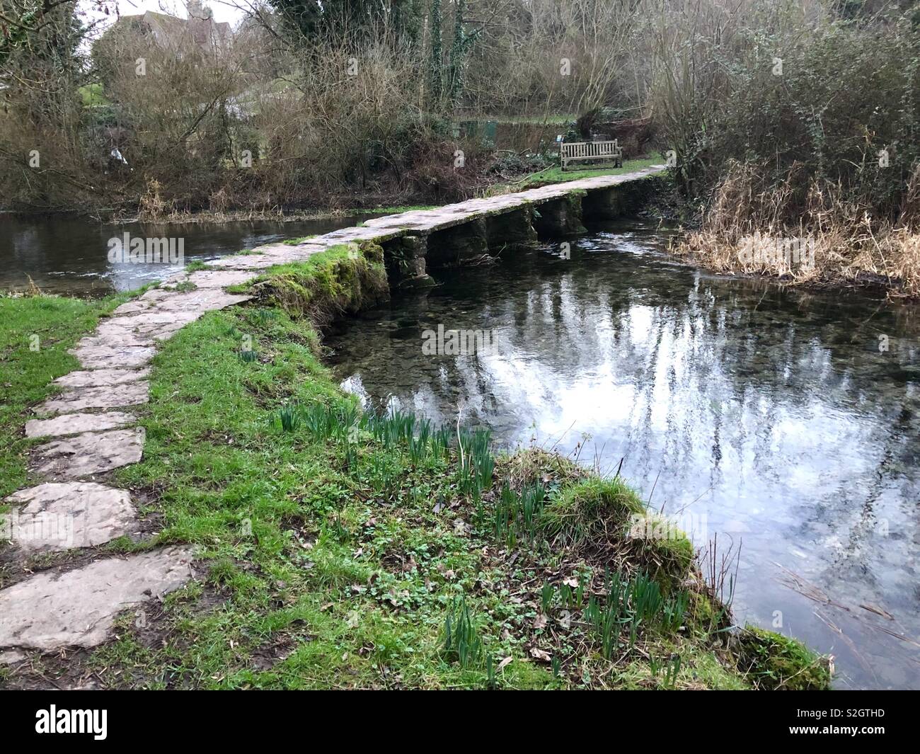 A rare Medieval clapper bridge crosses the rivet at Eastleach Turville ...