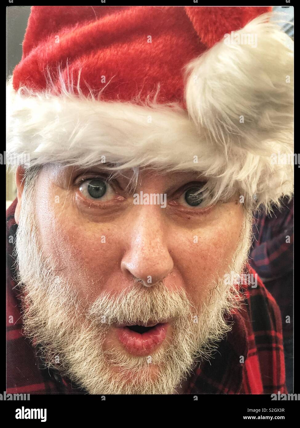 Man looking like Santa in a Santa hat Stock Photo - Alamy