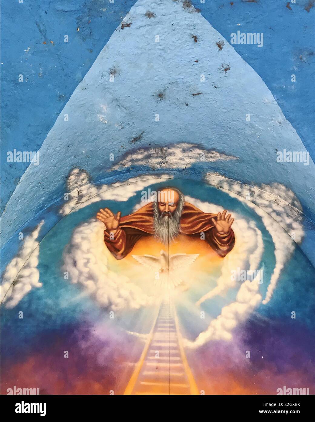 A painting of God and the Holy Spirit on top of a ladder decorates the ...