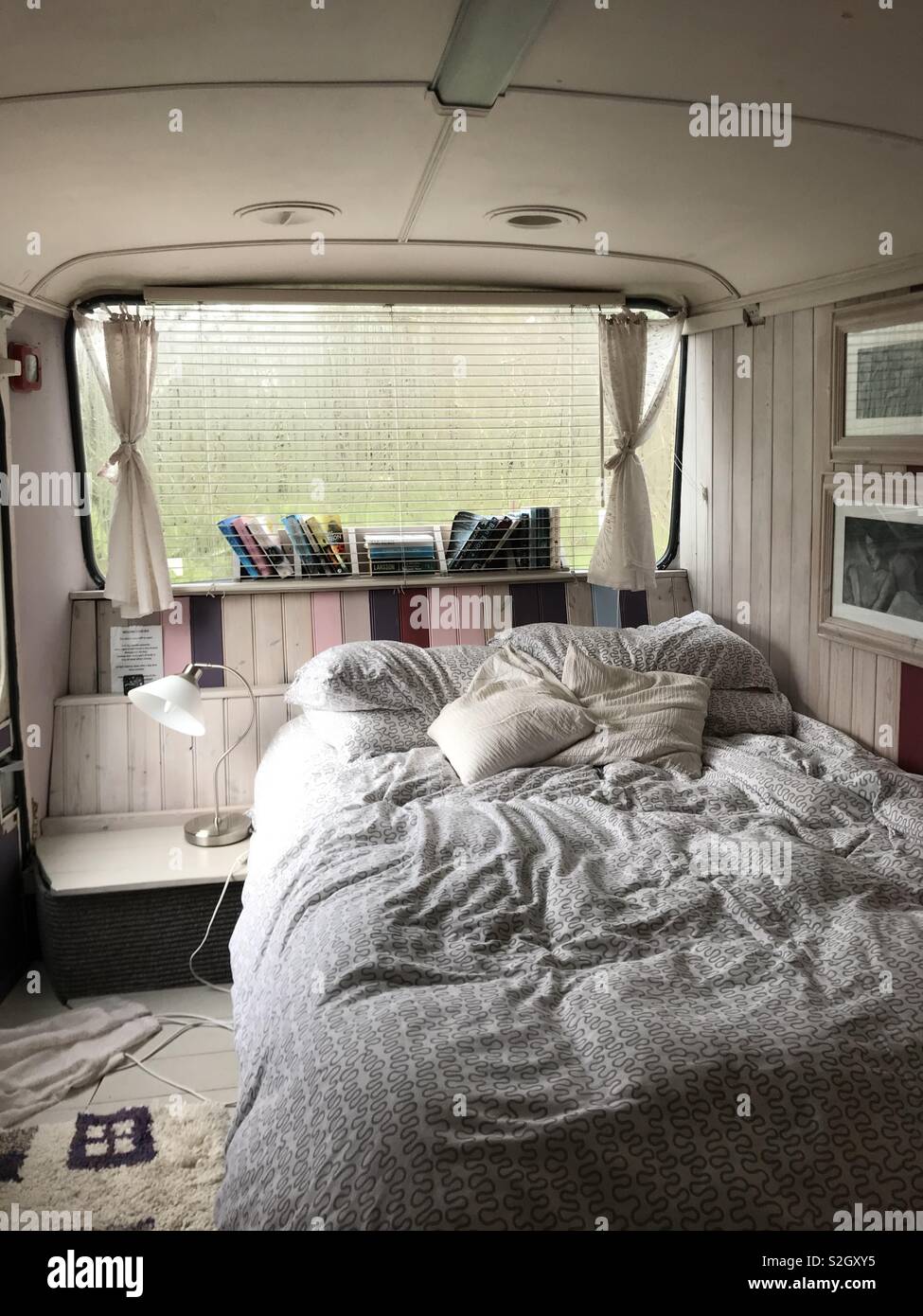 A small bedroom within a refurbished school bus Stock Photo - Alamy