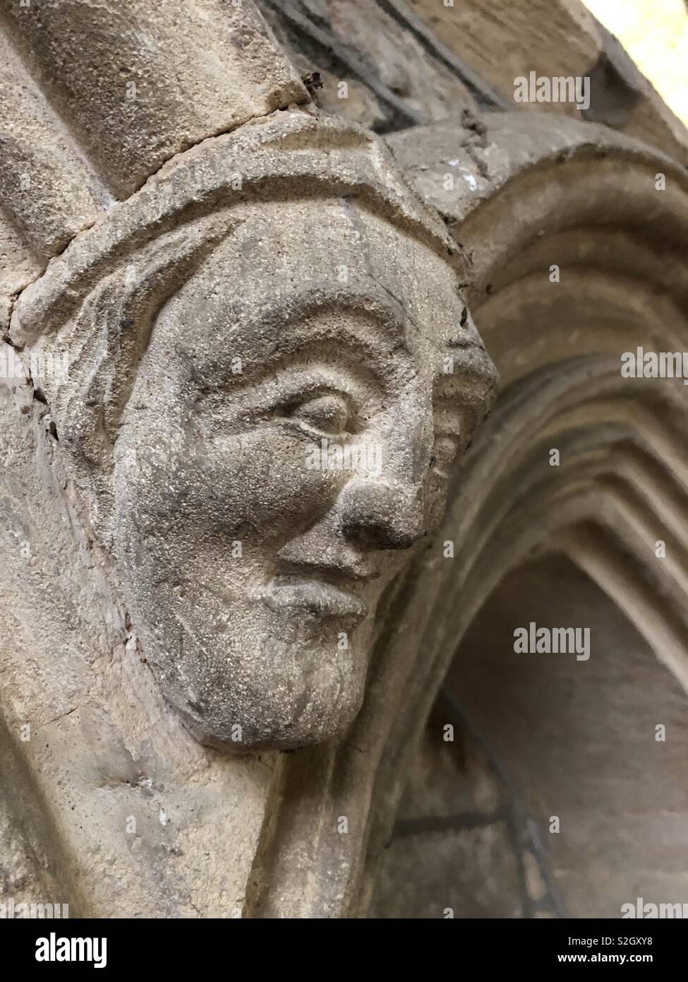 A sculpture portrait head of a Bishop with a smug expression and a ...