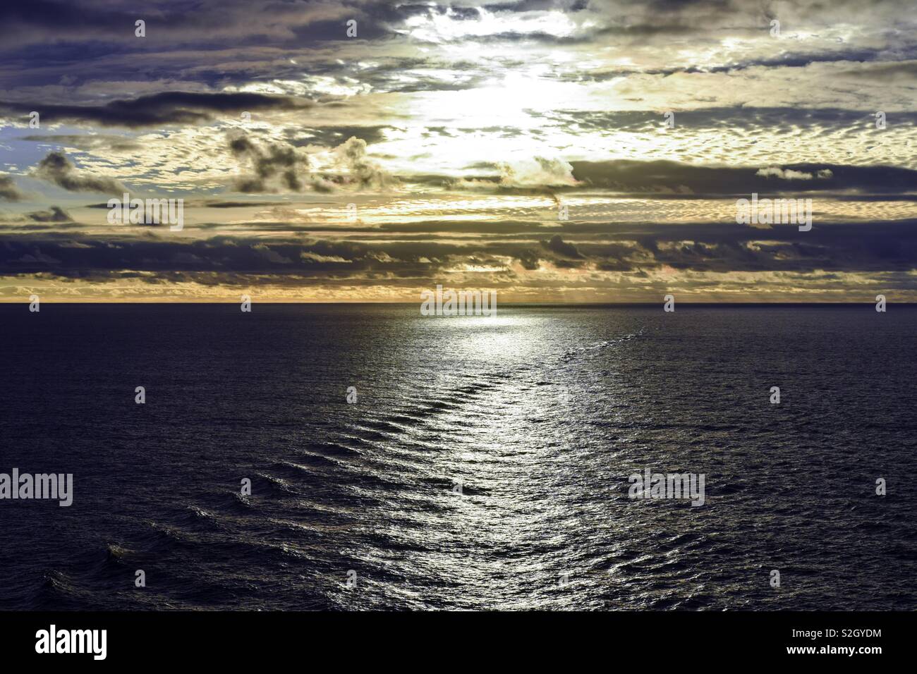 Sunlit clouds at sea Stock Photo - Alamy