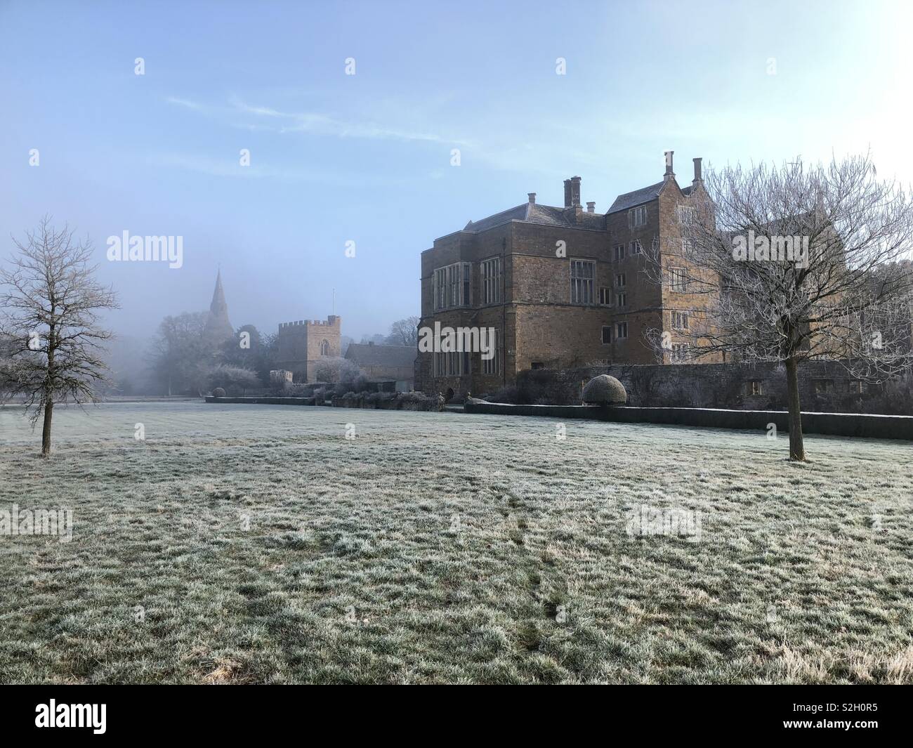 Broughton Castle, Gatehouse and church Tower after a hard winter air ...