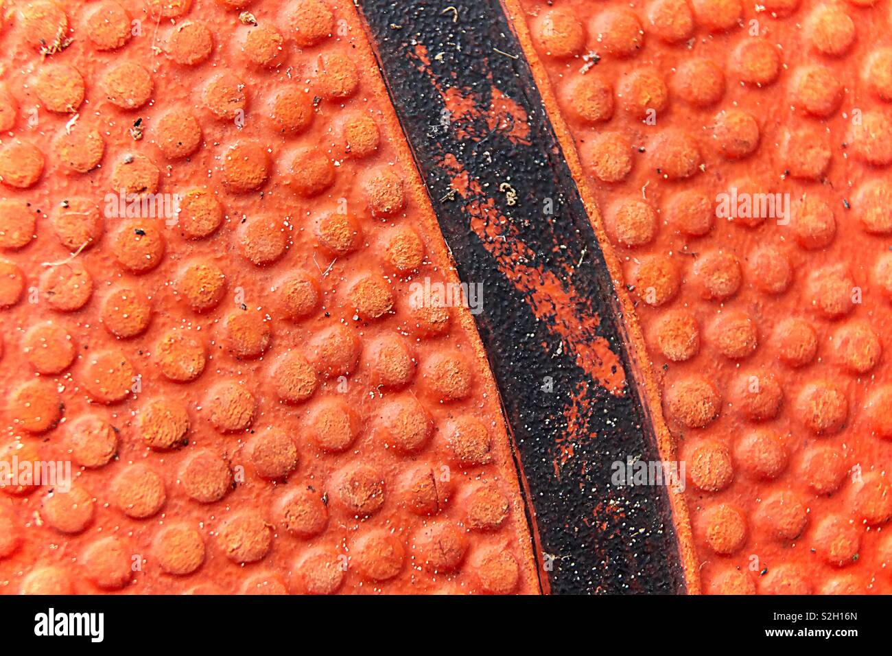 the structure of a used orange basketball shows the small nubs and ...