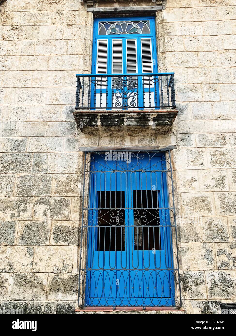 Blue doors and window balcony with decorative iron work in old Havana ...
