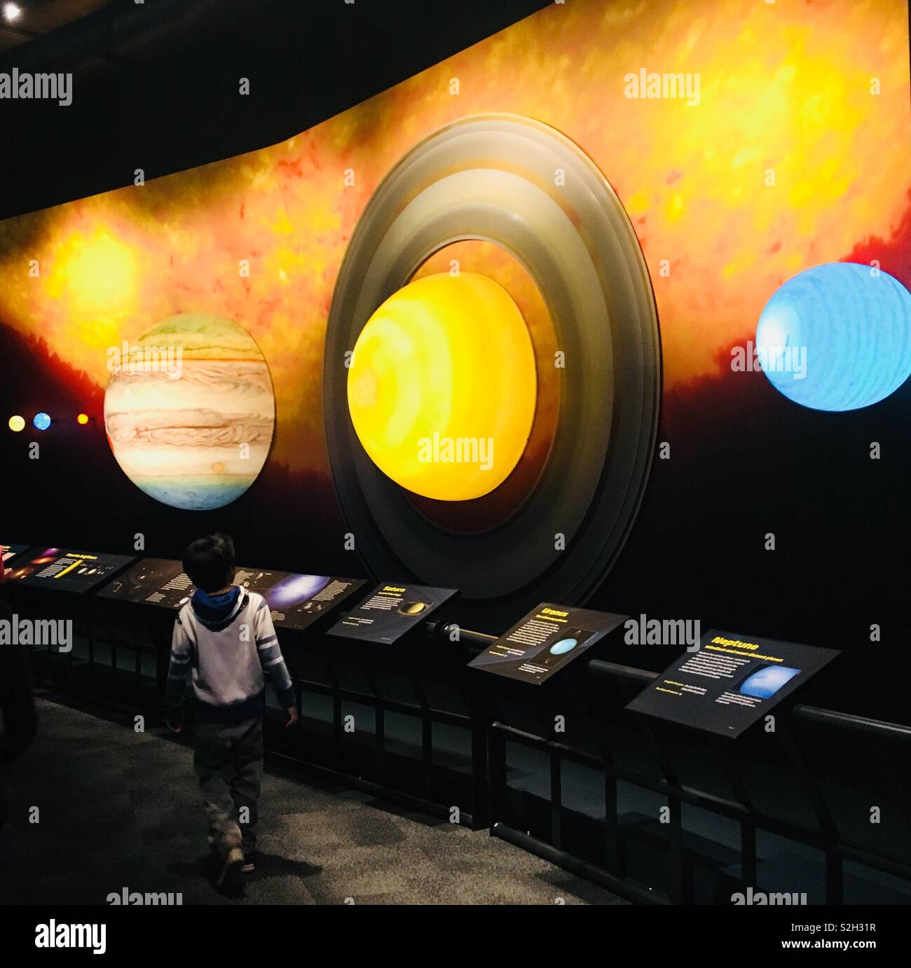Boy learning about our solar system Stock Photo - Alamy