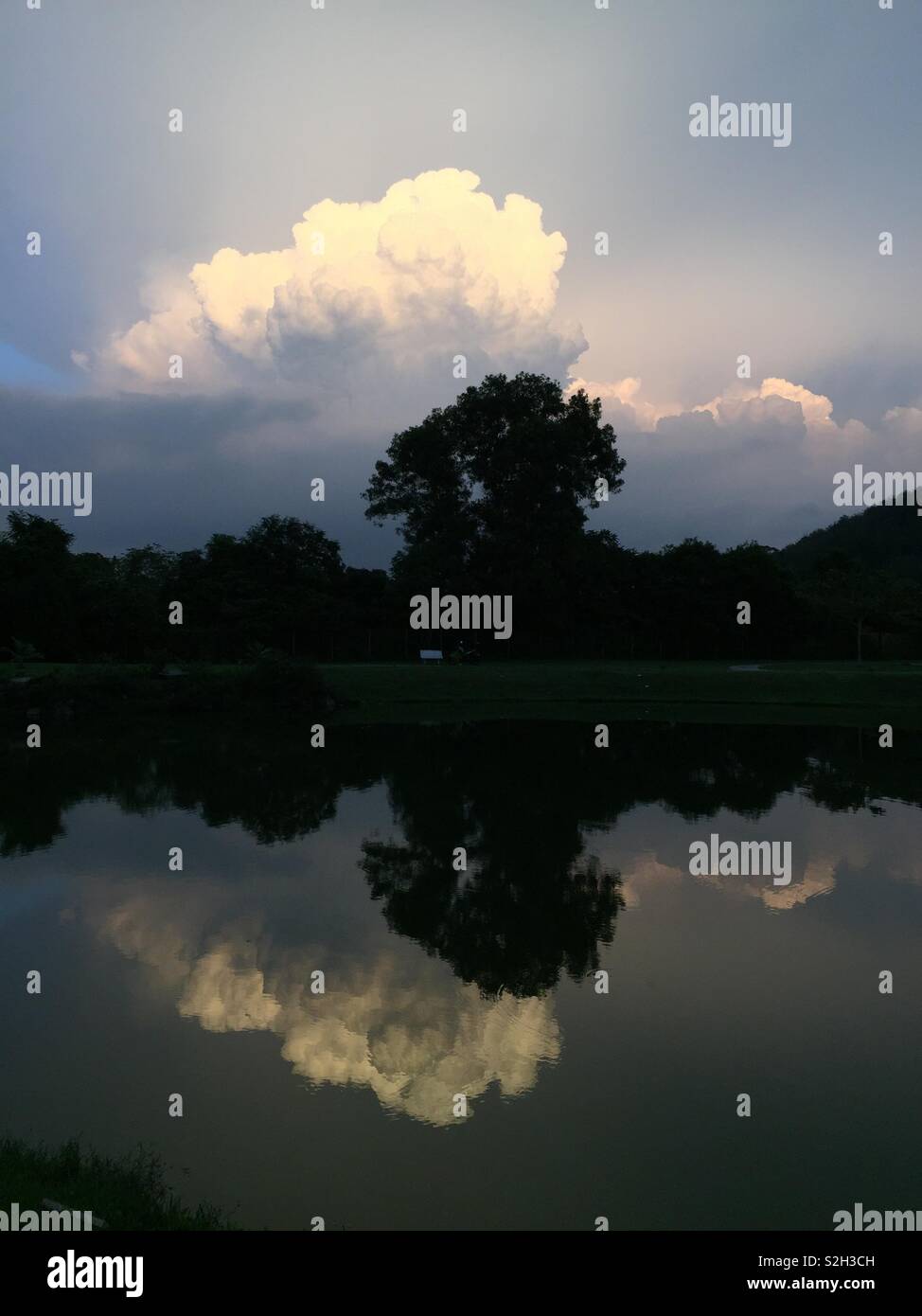 Raincloud reflects on water Stock Photo - Alamy