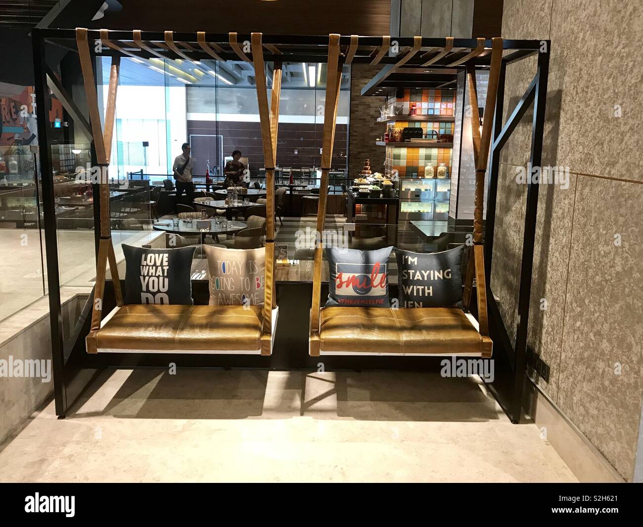 Seating area, 2 swings with cushions in a hotel lobby Stock Photo - Alamy