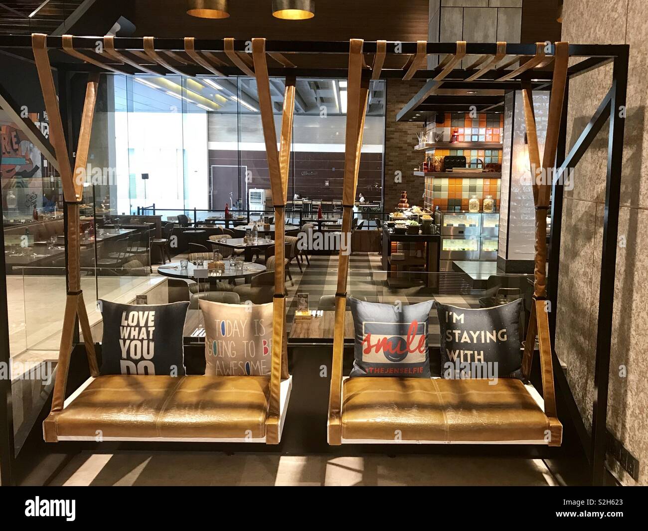 Seating area, 2 swings with cushions in a hotel reception Stock Photo ...