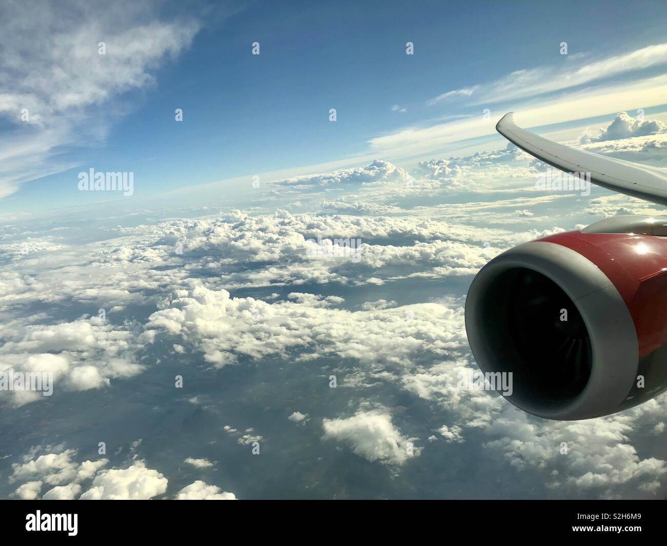View of clouds in sky from Boeing 787aeroplane with jet engine and ...