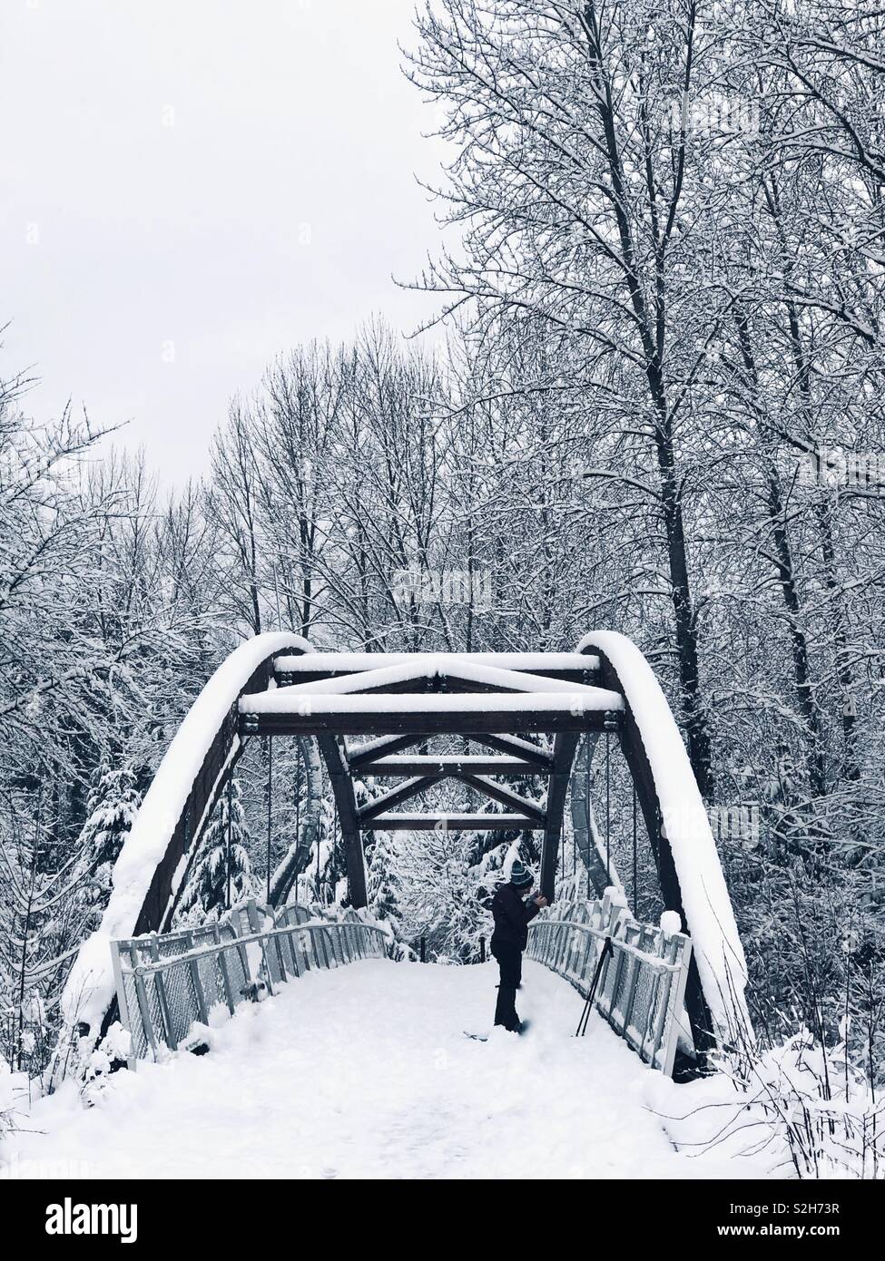 Photographer on the snow covered pedestrian bridge in Issaquah, WA ...