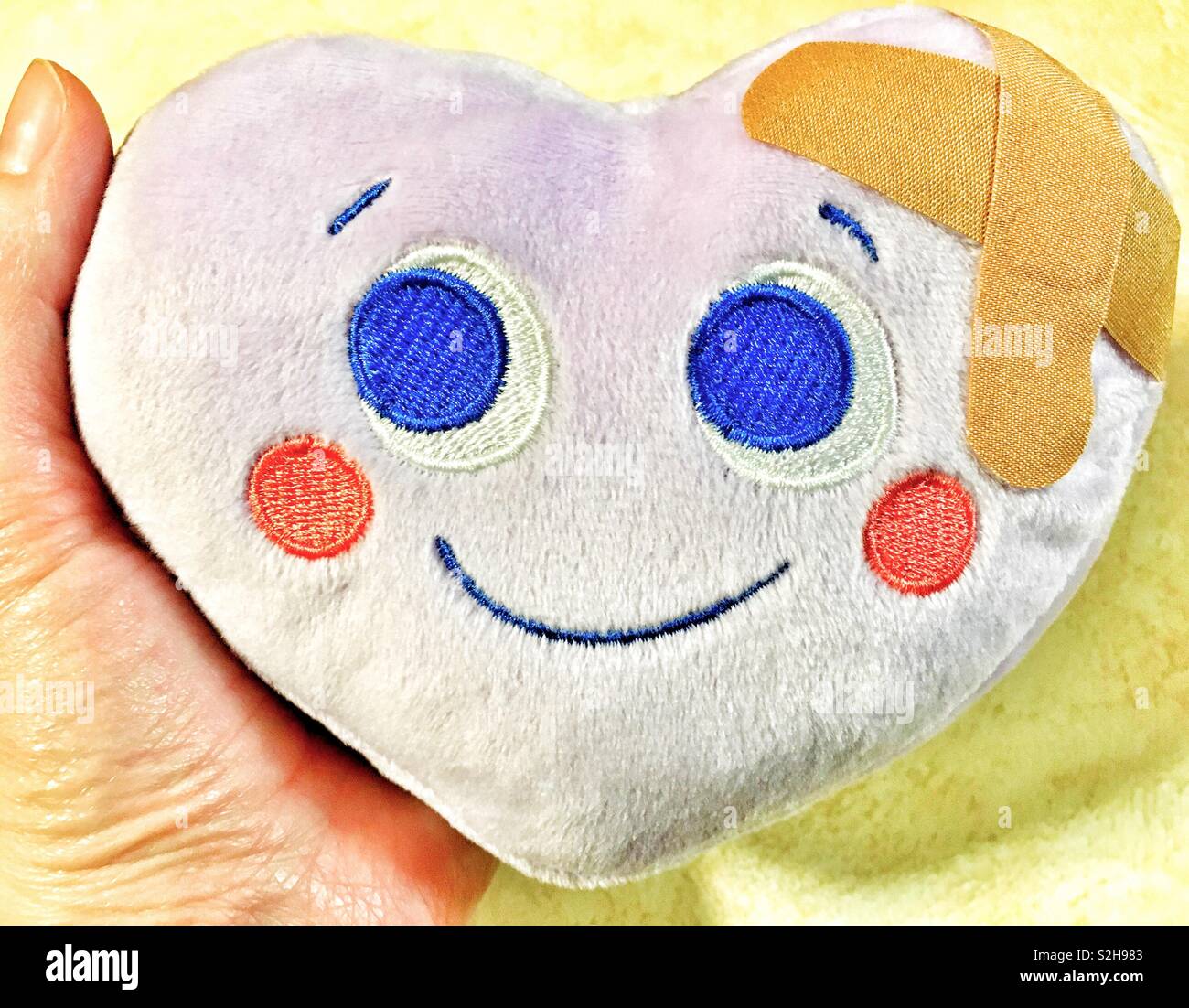 Smiling light purple heart stuffed toy with blue eyes rosy cheeks and ...
