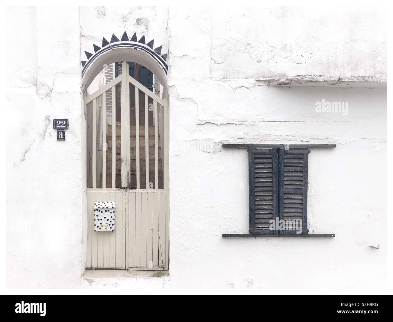 Wall of White House with pretty gate & shuttered window Stock Photo - Alamy