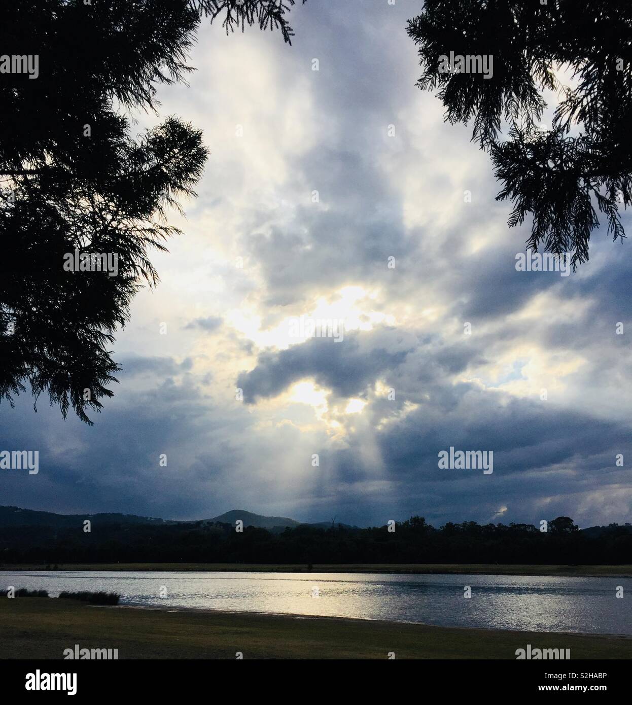 Sun rays coming through clouds hi-res stock photography and images - Alamy