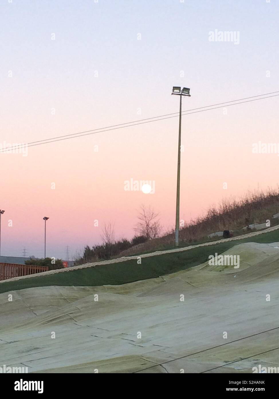 Pink sunset with the moon Stock Photo - Alamy