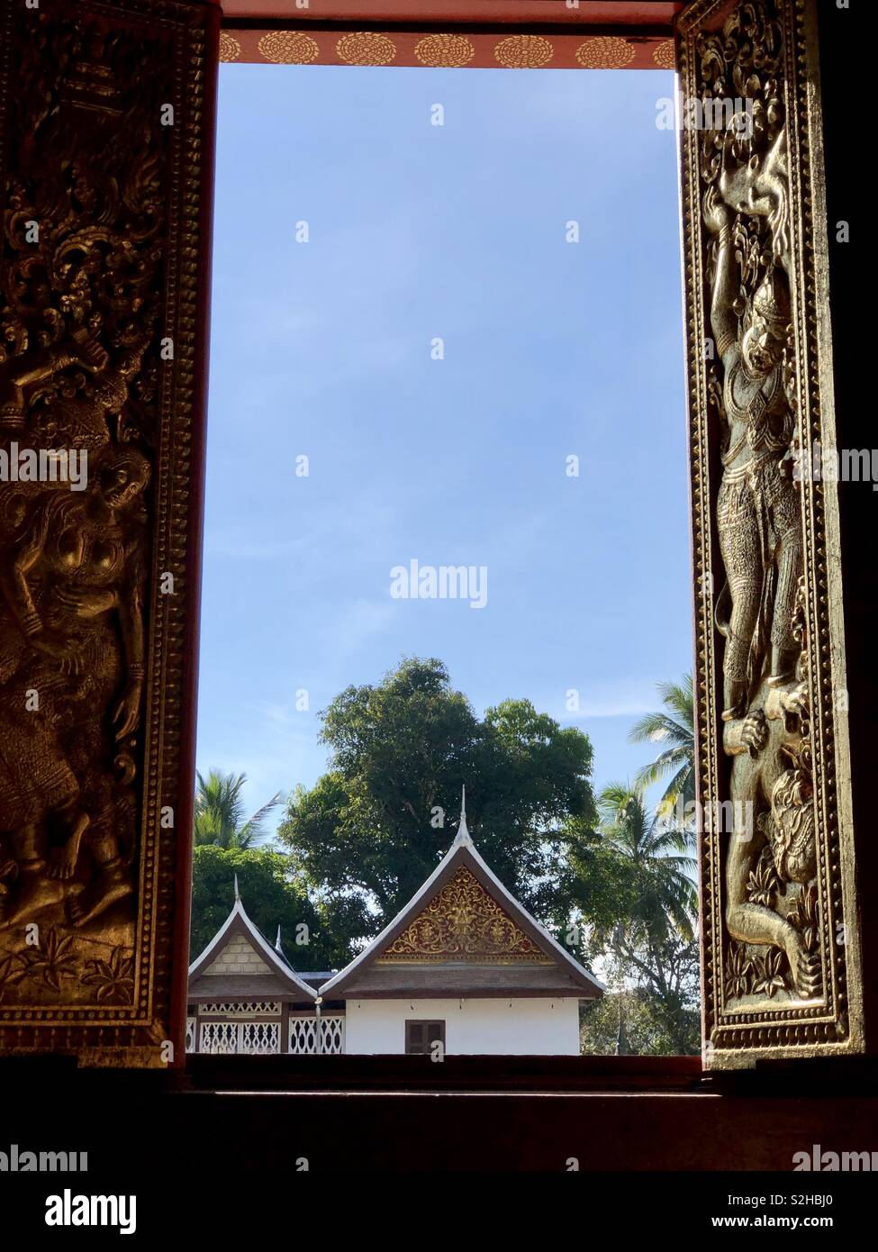 View out of temple window across rooftops in Luang Prabang Laos Stock ...
