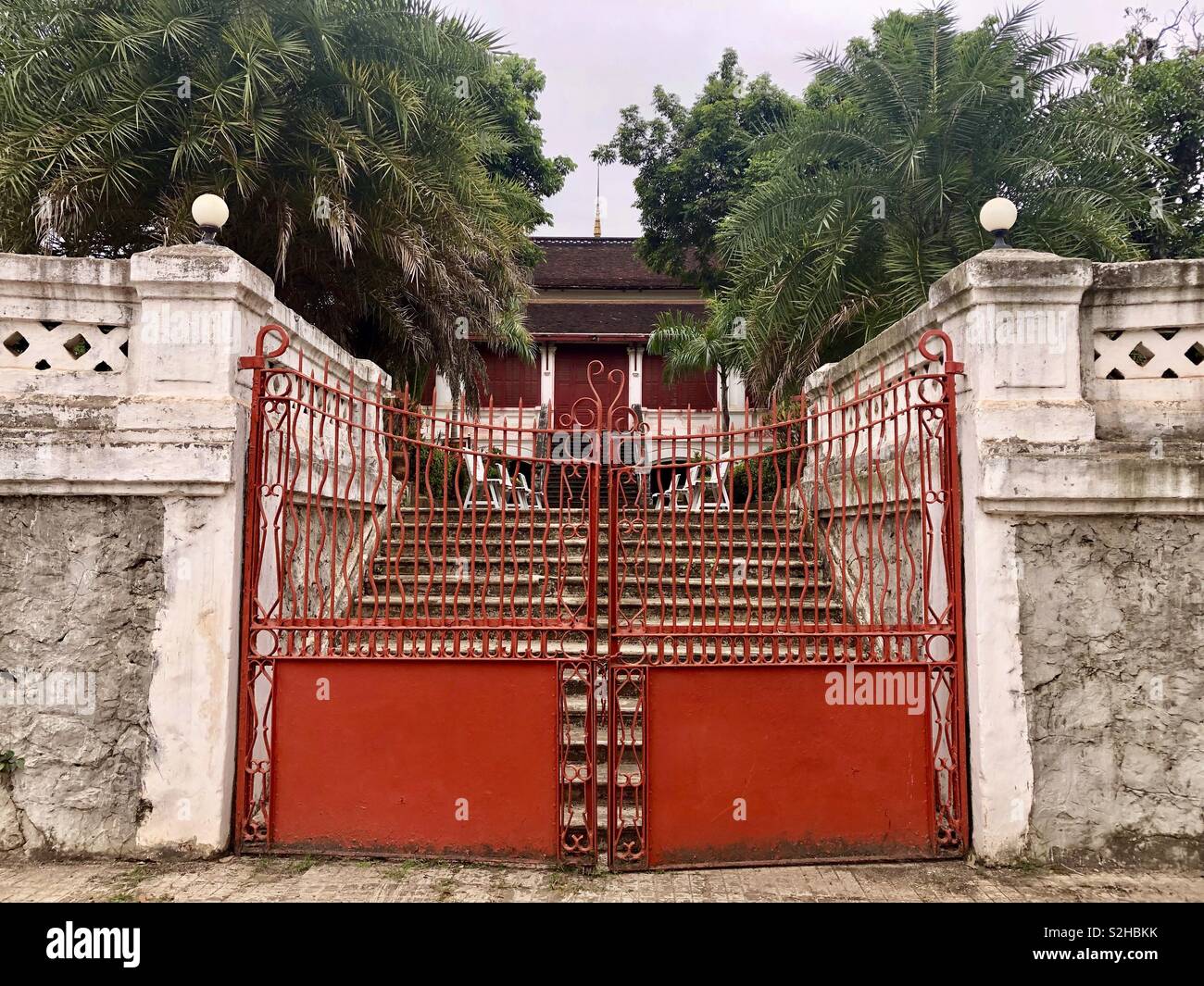 Closed red gates outside old building in Luang Prabang Stock Photo - Alamy