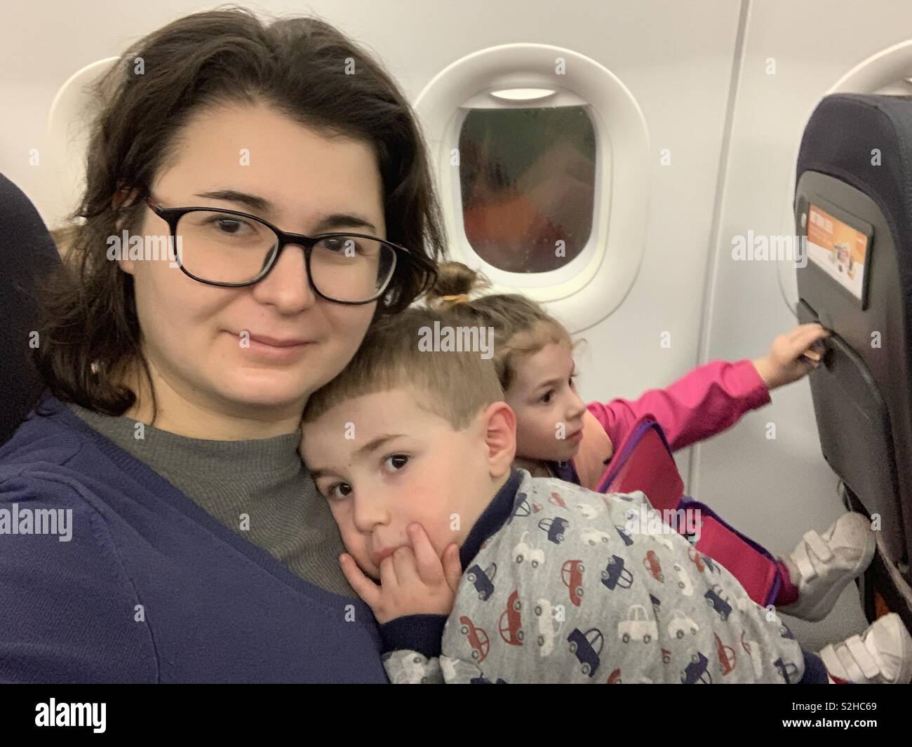 Family on an airplane Stock Photo - Alamy