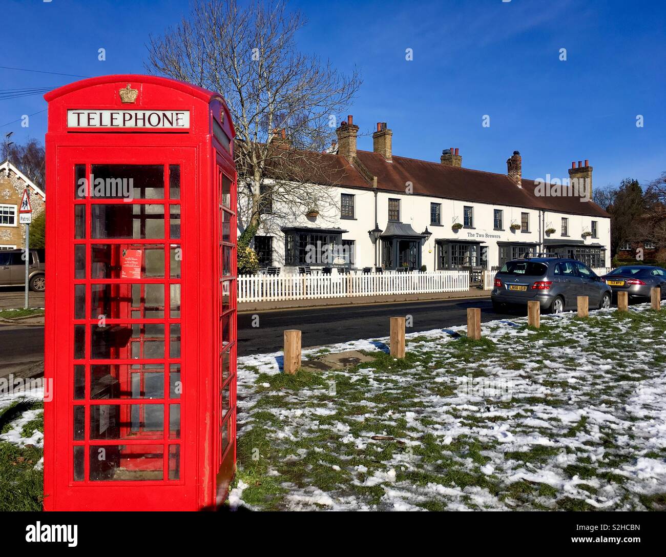 British red telephone box by village pub Stock Photo - Alamy