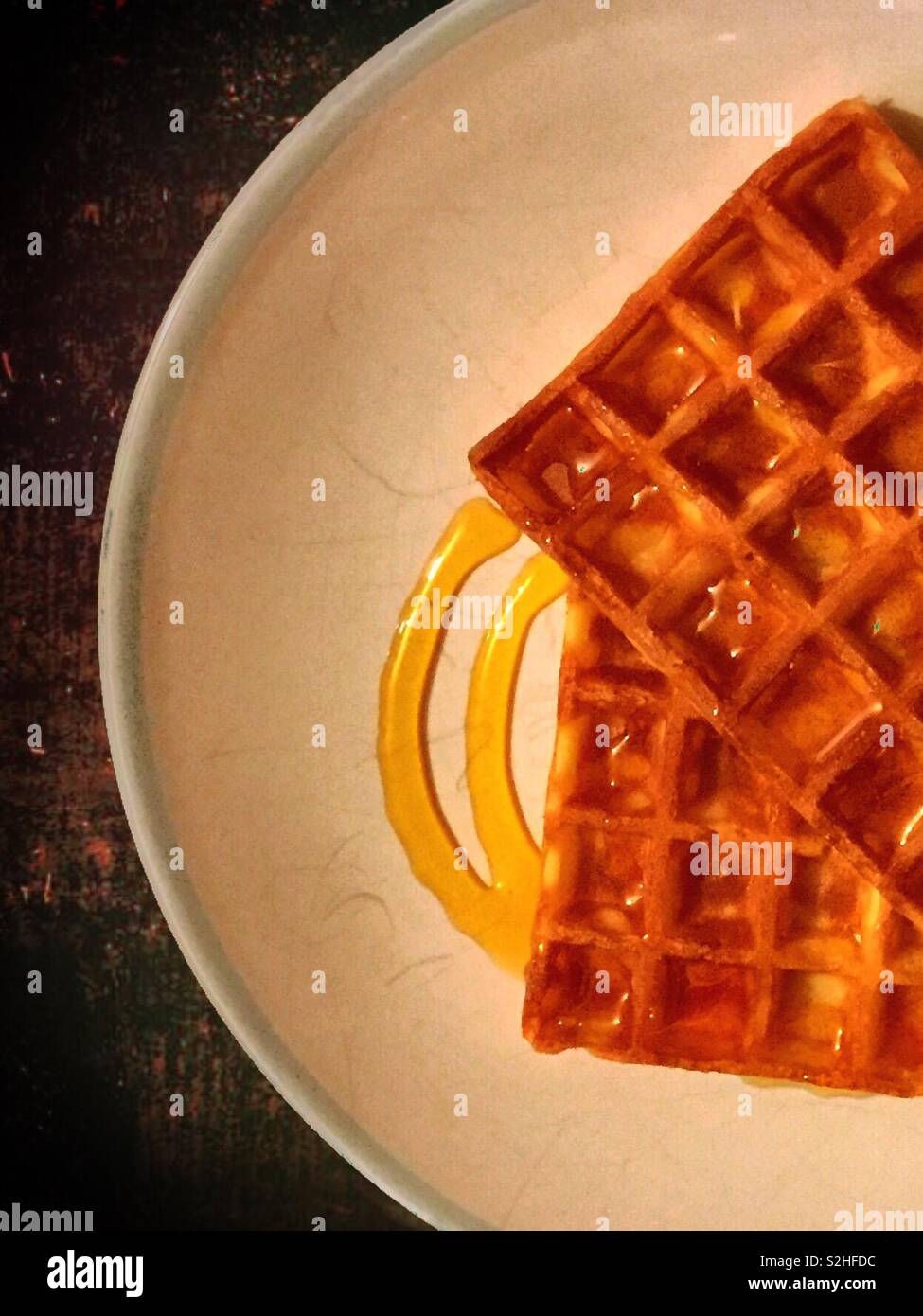 Waffles with sweet sticky syrup drizzled over the top for a morning ...