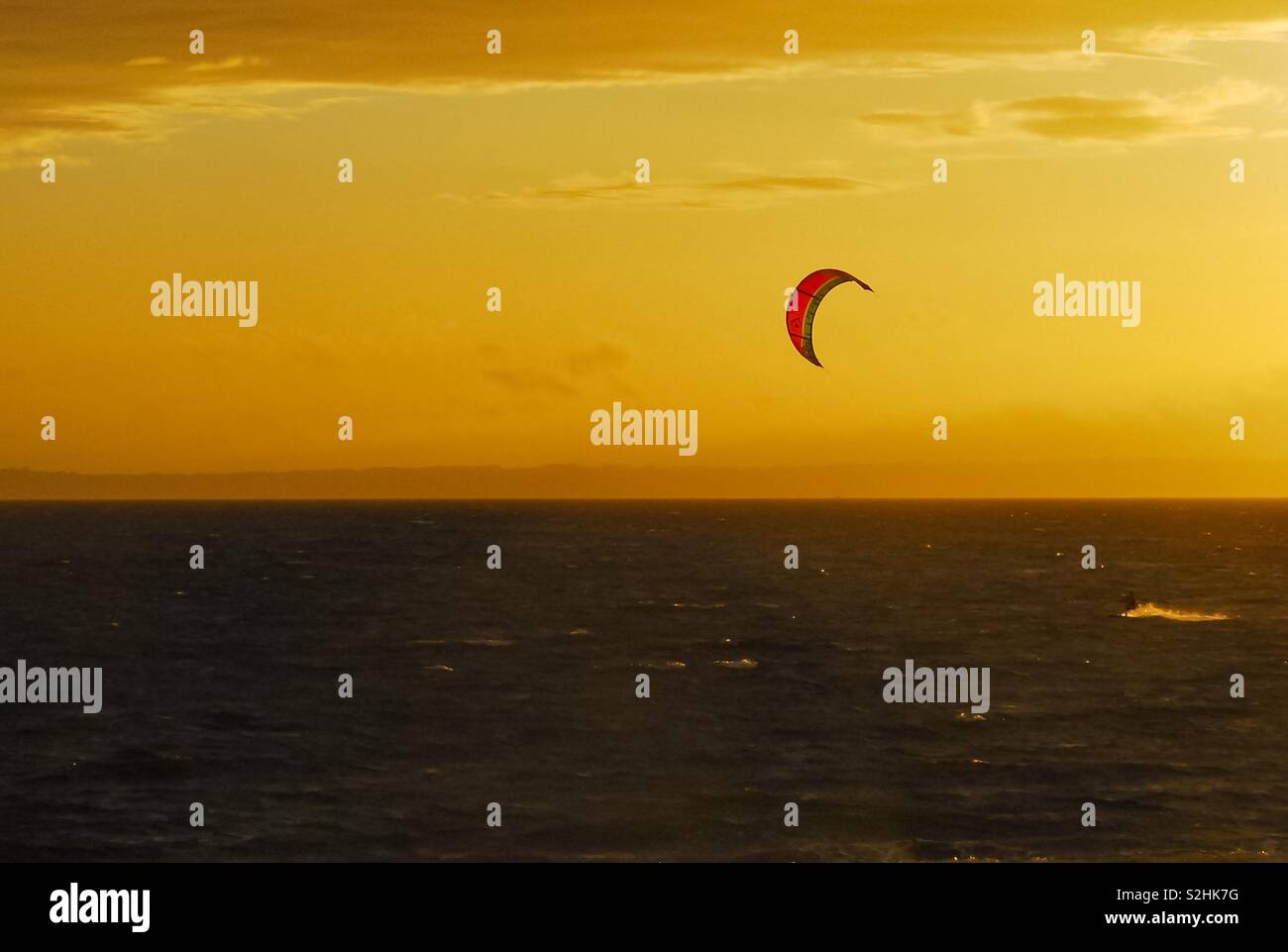 Sunset with paraglider Stock Photo - Alamy