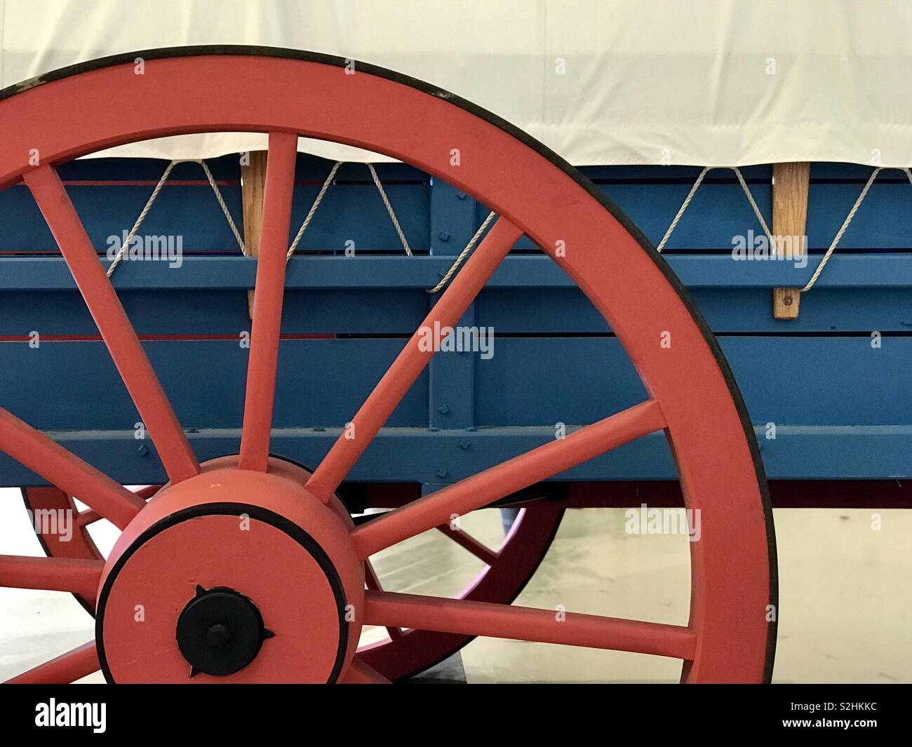 Old cart with white fabric roof and big red wheel Stock Photo - Alamy