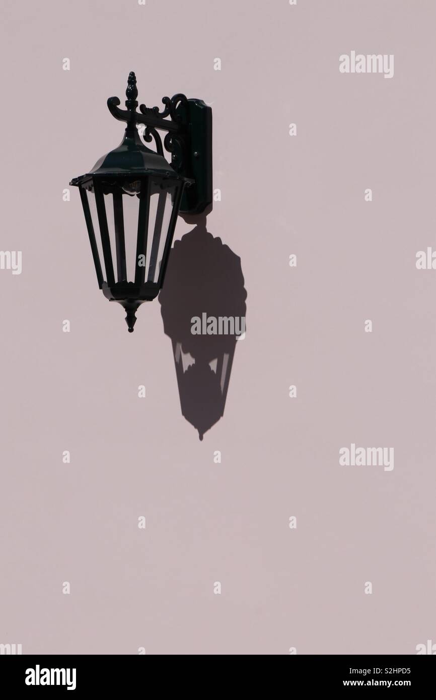 Lamp and it's shadow on a pink wall Stock Photo - Alamy