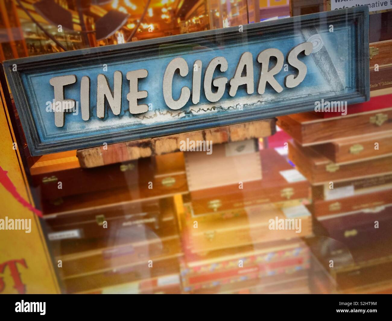 A display of wooden cigar boxes in a window of a retail smoke shop in ...