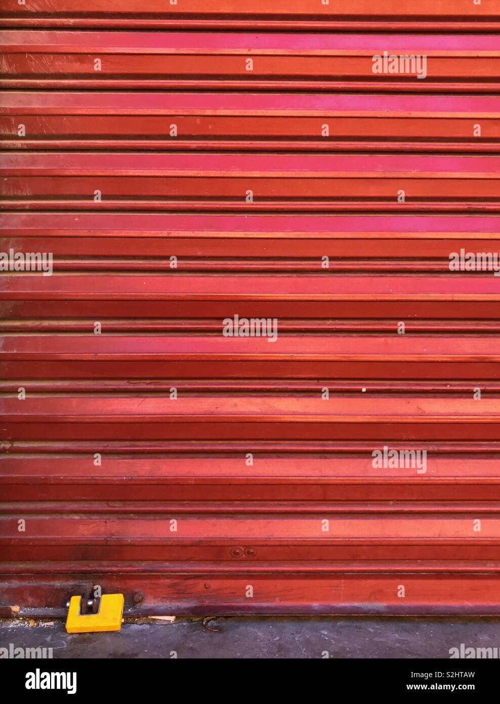 Little Yellow Lock. Bright yellow lock at the bottom of vivid red slide ...