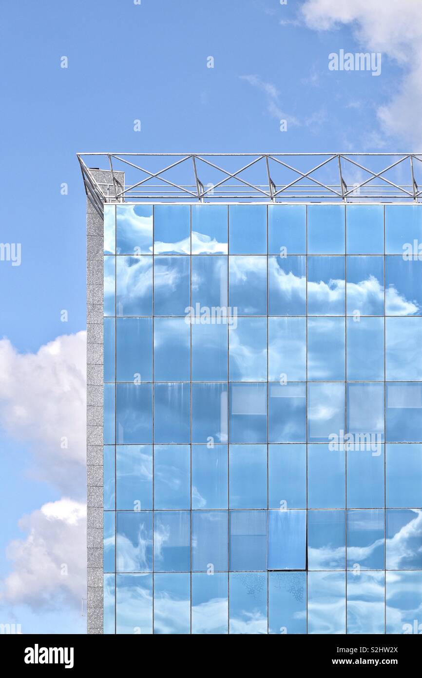 Mirrored windows with clouds reflection Stock Photo - Alamy