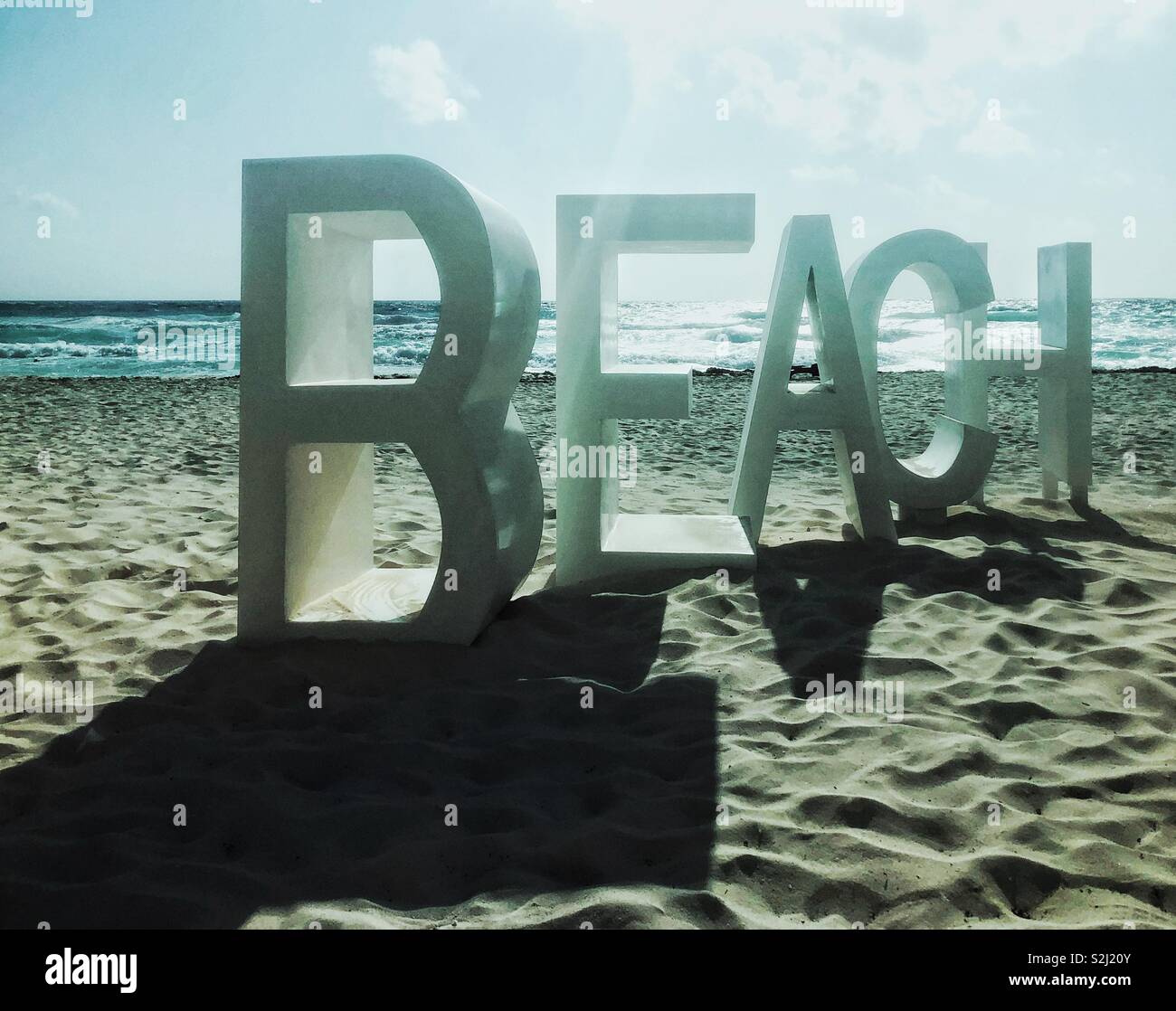 Word BEACH in large letters on sand in Cancun, Mexico Stock Photo - Alamy