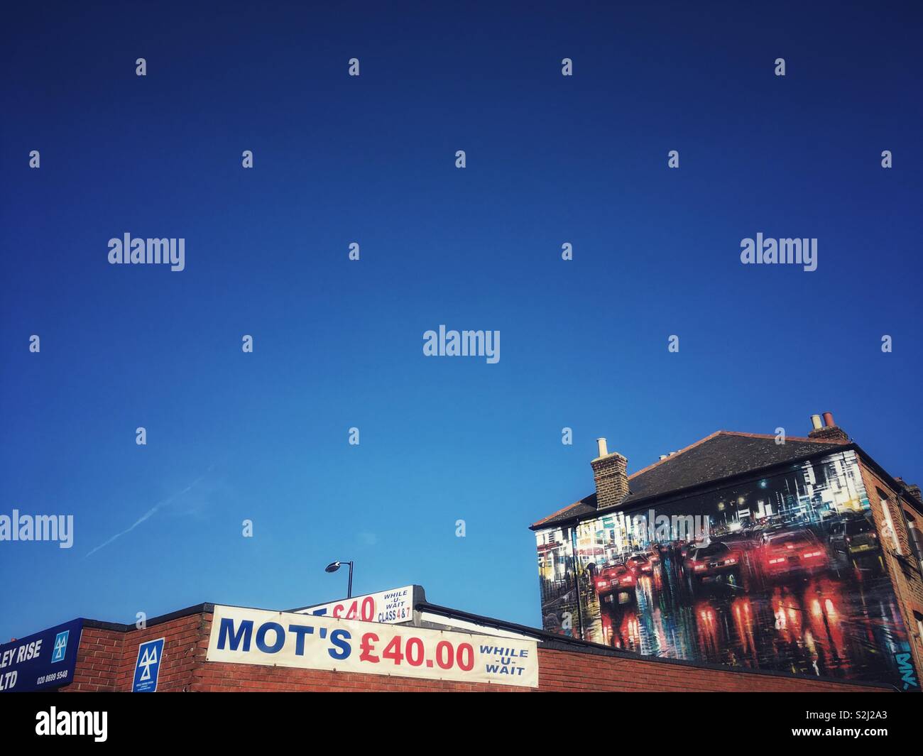 Garage advertising MOT’S on Brockley Rise, London in England Stock ...