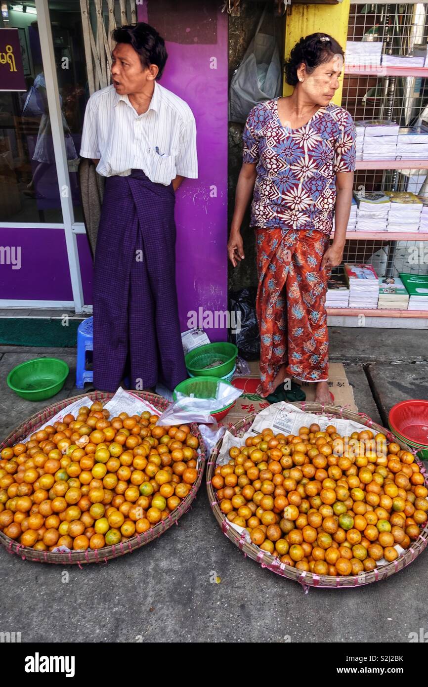 Two Burmese people selling fruits on the streets of Myanmar Stock Photo ...