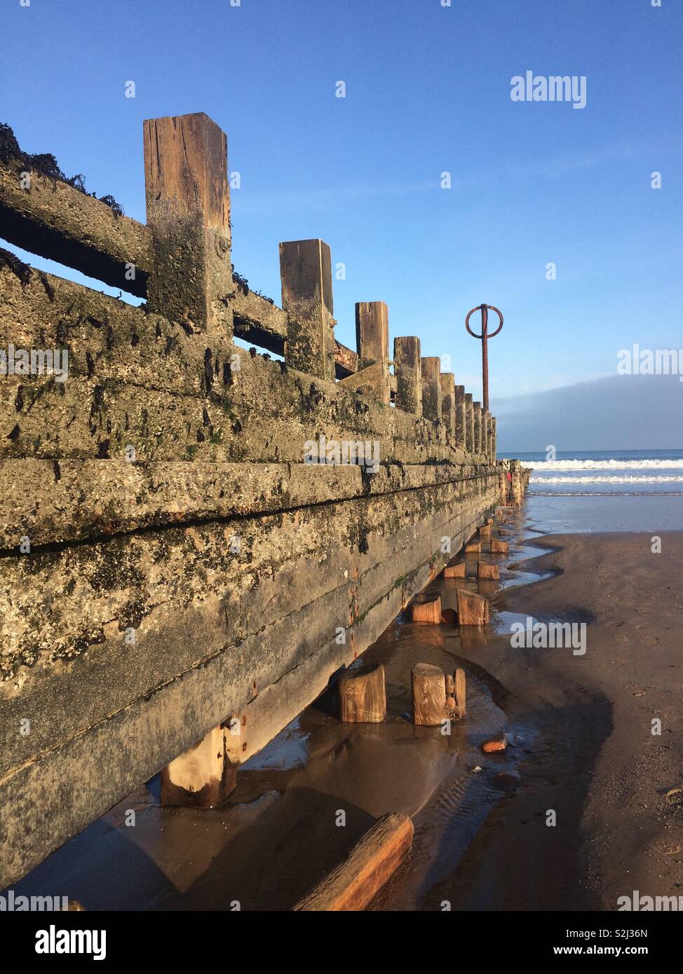 Wooden fence on the beach Stock Photo - Alamy