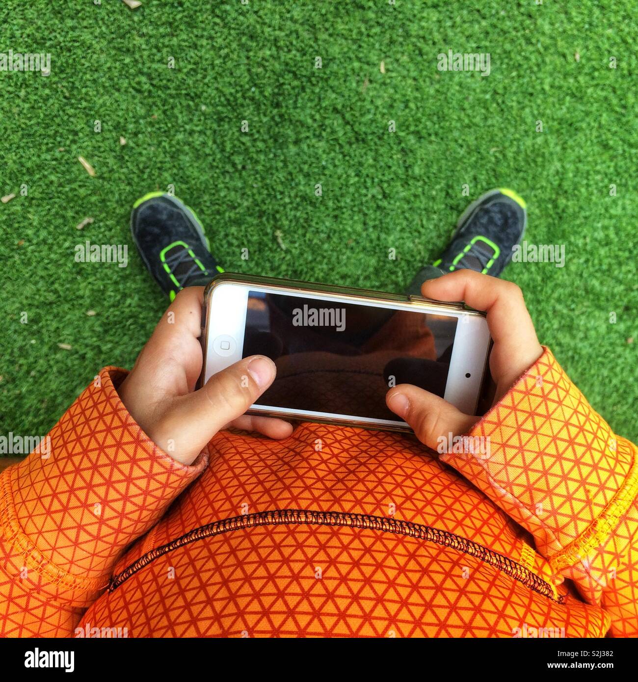 Young boy playing with a smartphone outside Stock Photo - Alamy