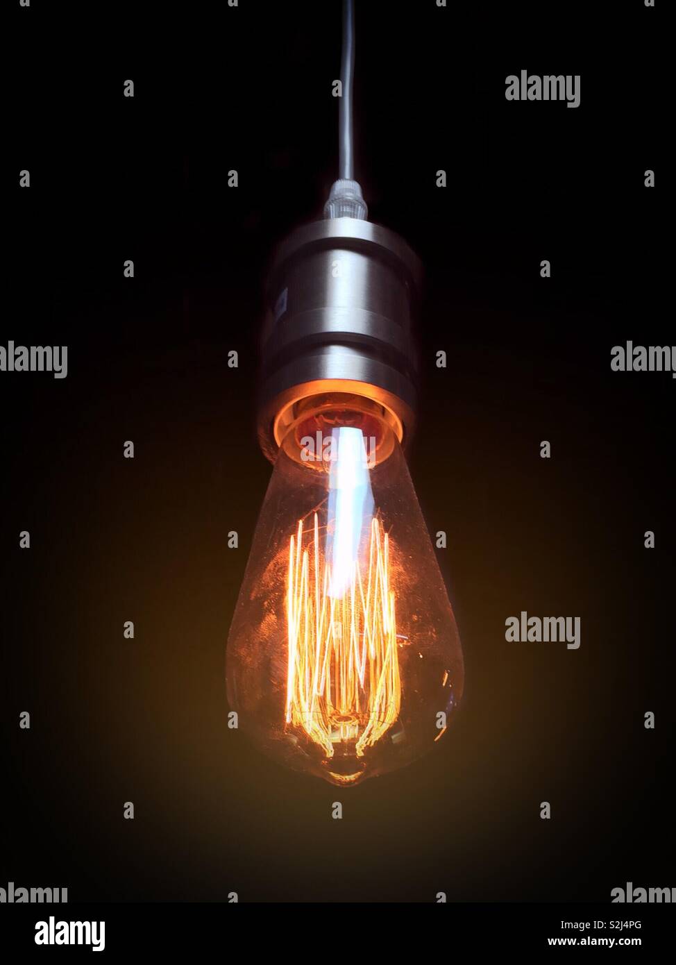 Warm lightbulb with a glow. Idea. Vintage filament glowing with ...