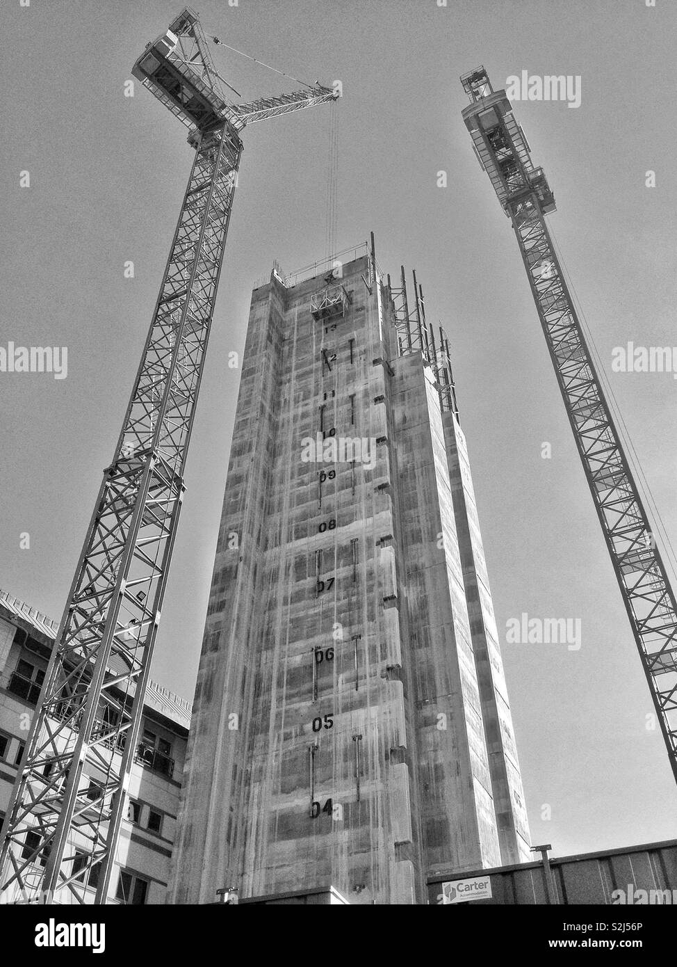Concrete new build core and cranes on a building site in the City of ...