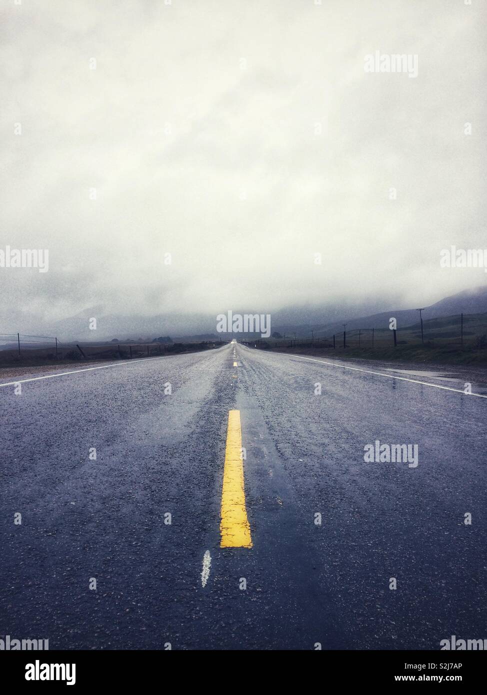 Follow the yellow line. Even if it rains Stock Photo - Alamy