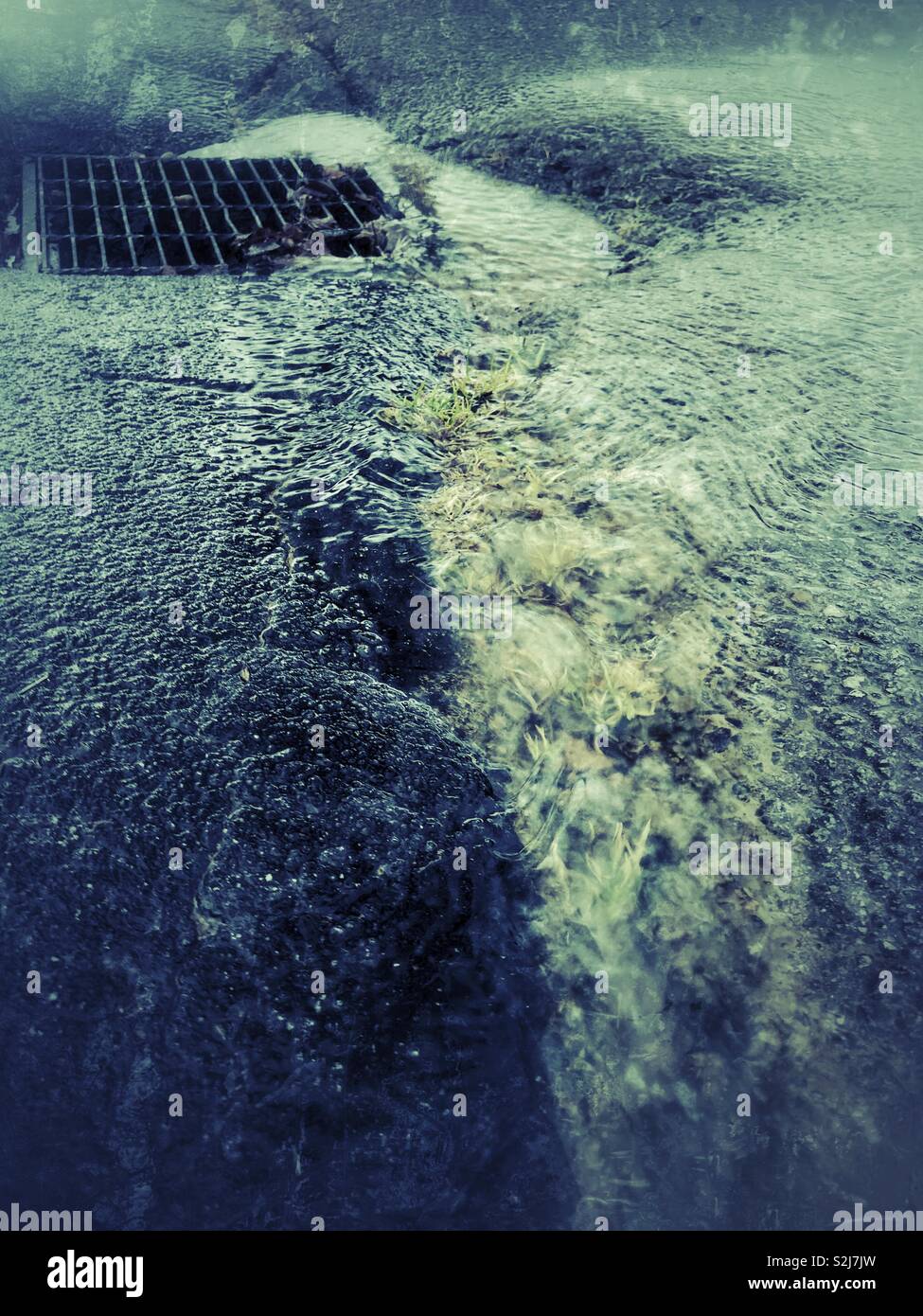 Grunge effect- rushing rain water to storm drain Stock Photo - Alamy