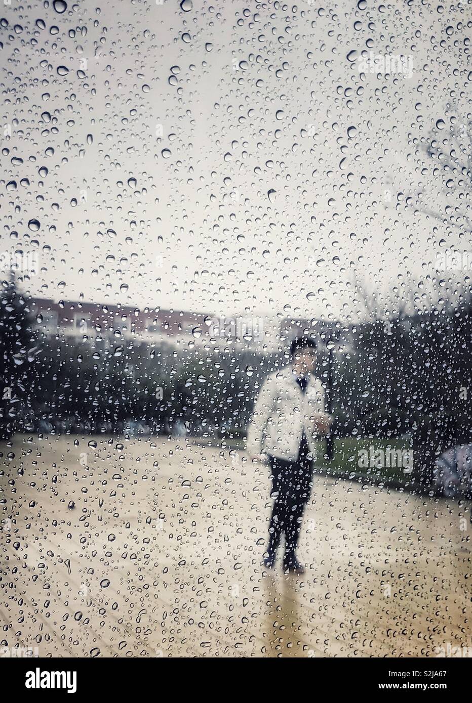 Man in the rain Stock Photo - Alamy