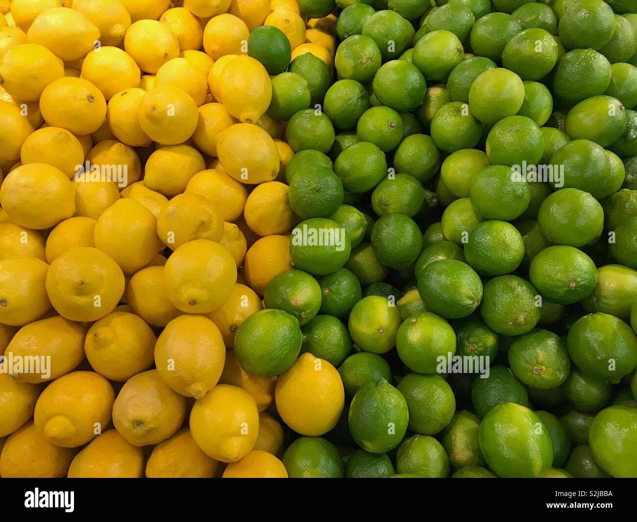 Organic lemons and limes are shown on display in a farmers market ...