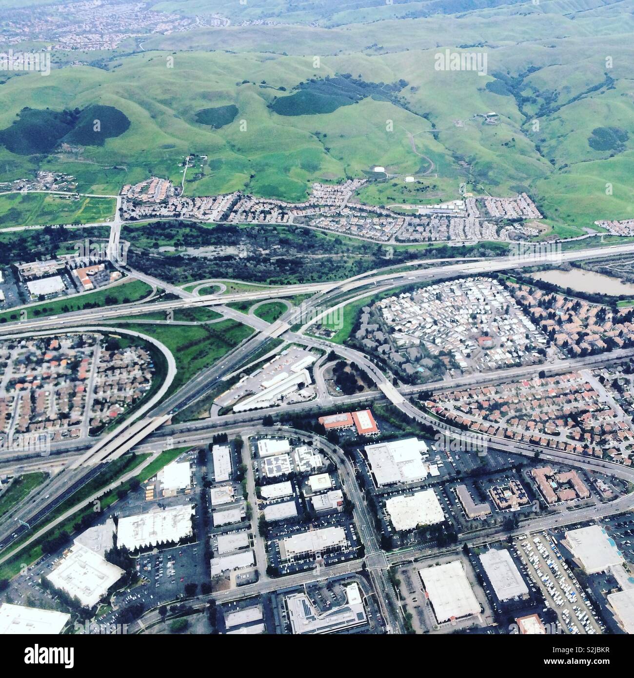 Highways and buildings seen from an airplane window while descending ...
