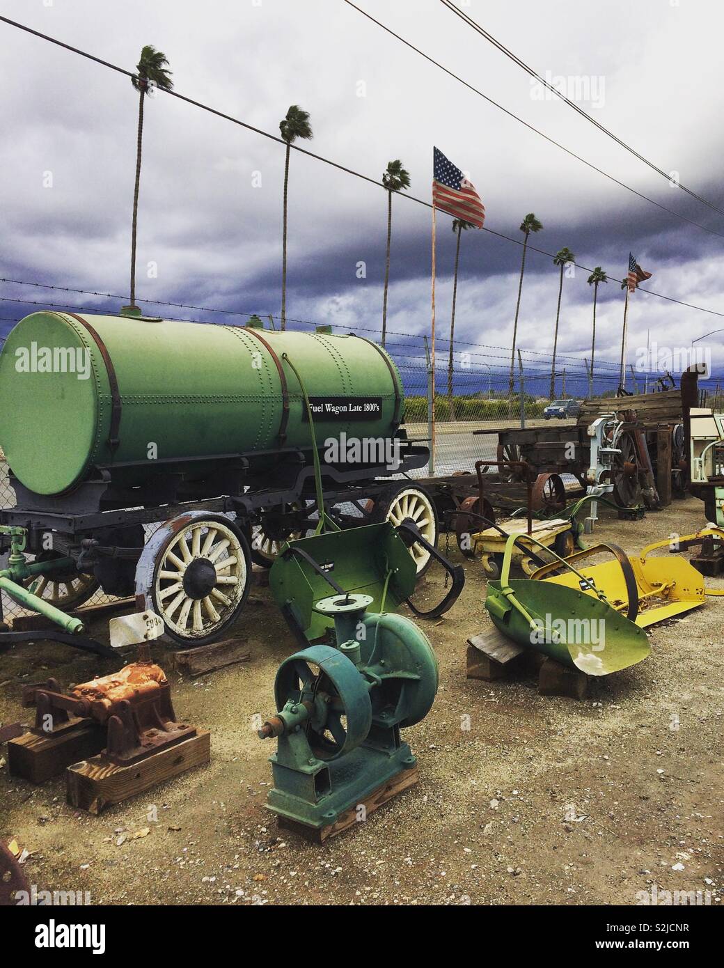 A 19th Century fuel wagon and other colorful farm equipment on display ...