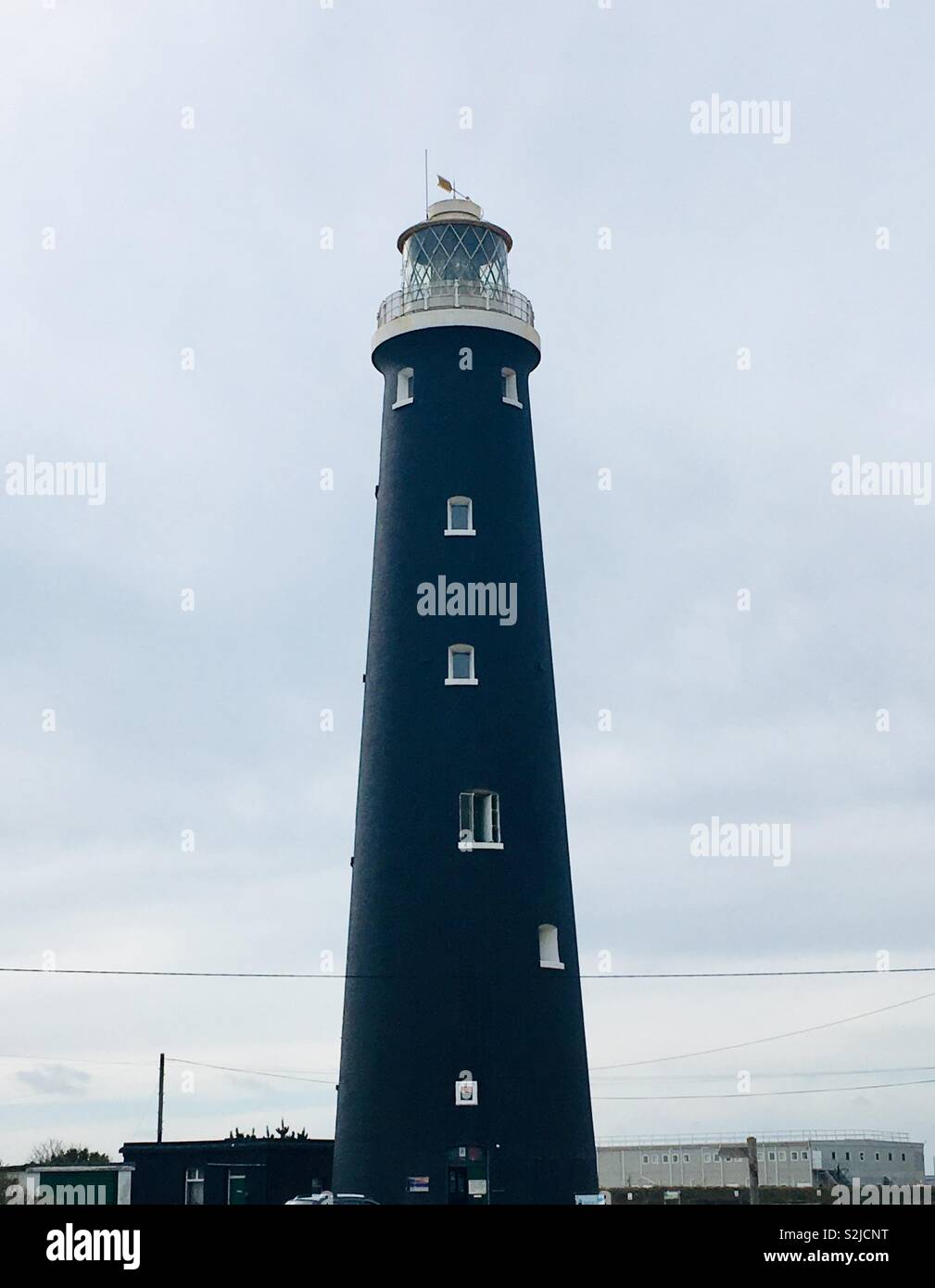 Black and white lighthouse against grey sky Stock Photo - Alamy