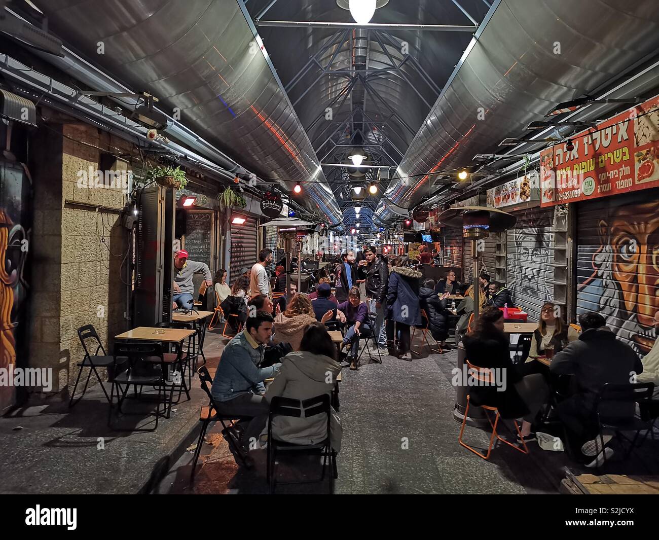 The vibrant Mahane Yehuda market in Jerusalem at night. Restaurants and ...