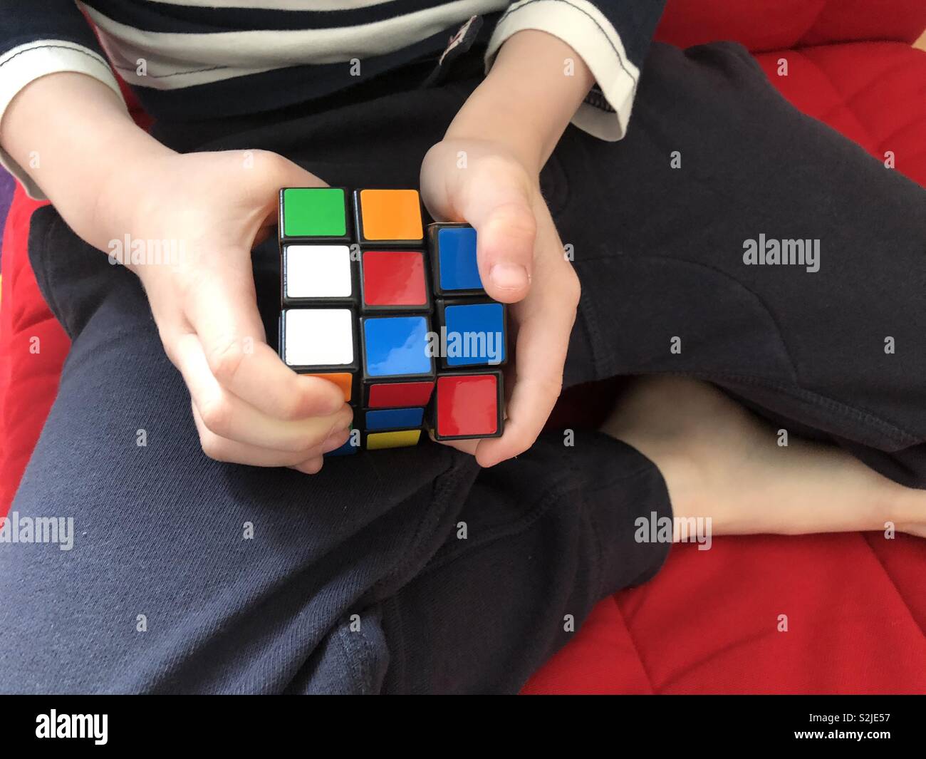 Small child playing with Rubik’s cube Stock Photo - Alamy