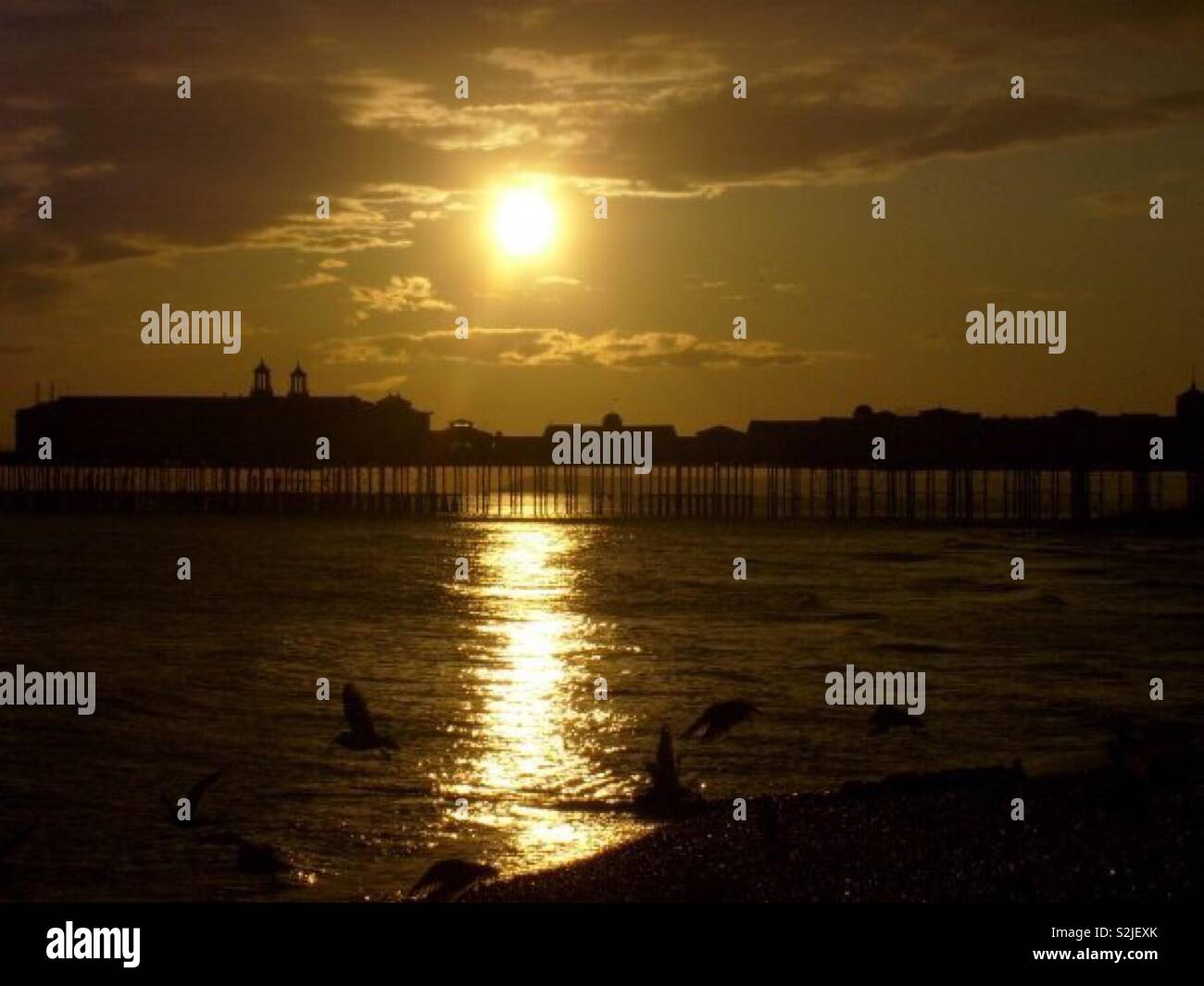 Sunset over pier Stock Photo - Alamy