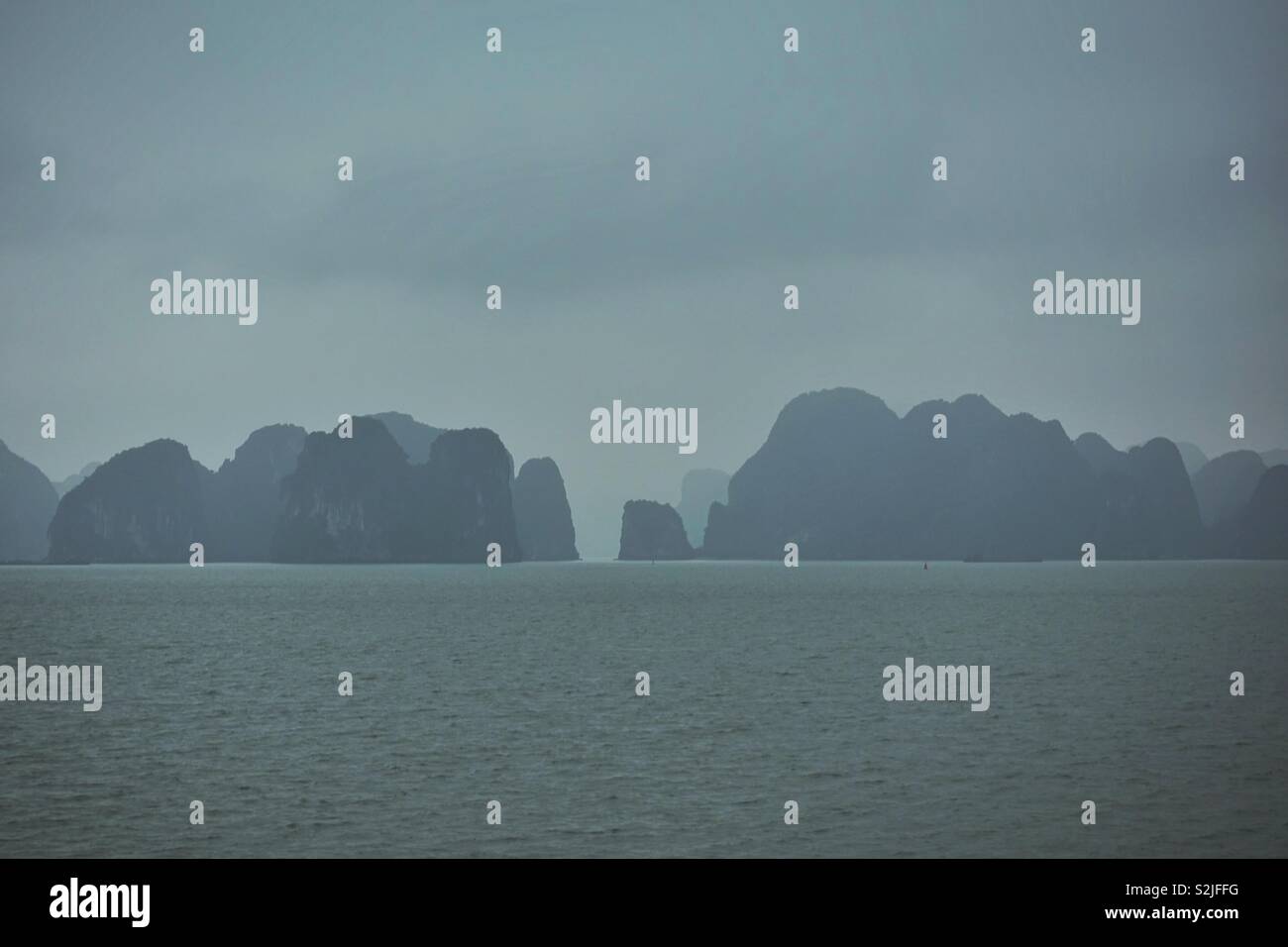 Vietnam, Ha Long Bay. On a rainy, misty, foggy day. Without boats. Gray ...