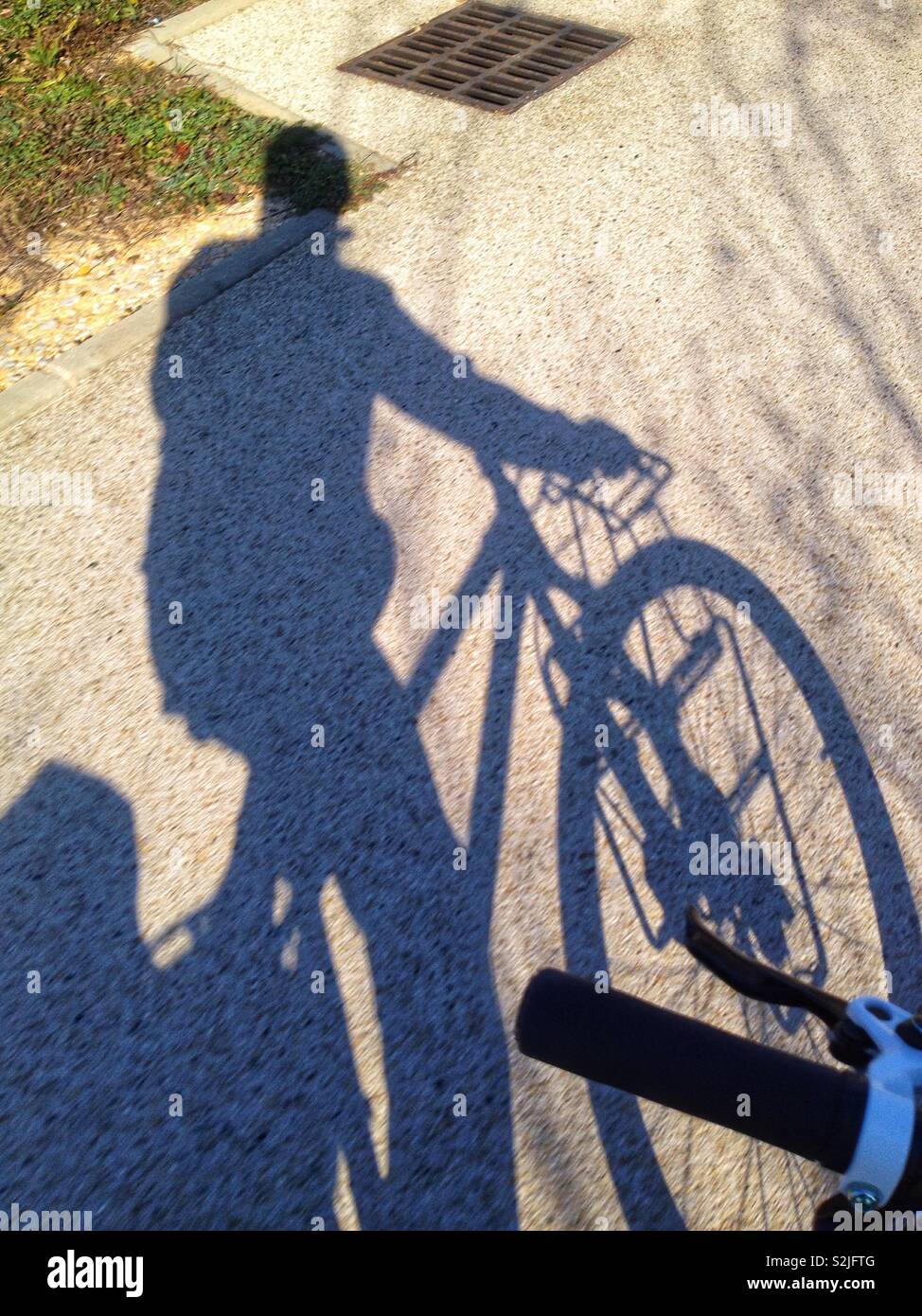Shadow of a cyclist on a bike path Stock Photo - Alamy