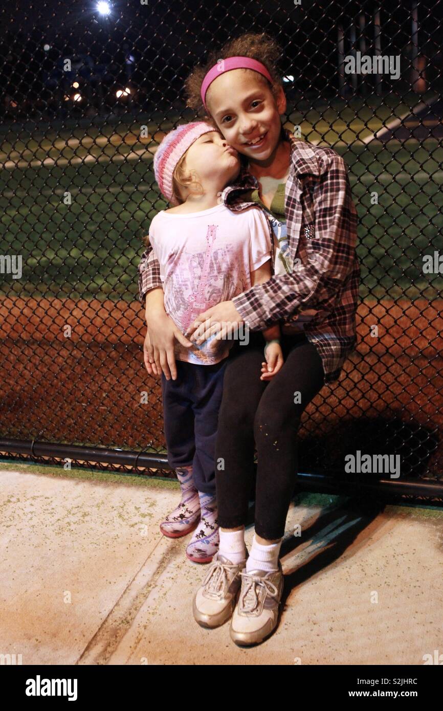 Two little sisters kissing hi-res stock photography and images - Alamy